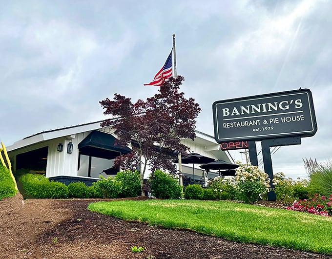 The classic white exterior of Banning's stands proudly under Oregon skies, American flag waving as if to say, "Good food happens here!"