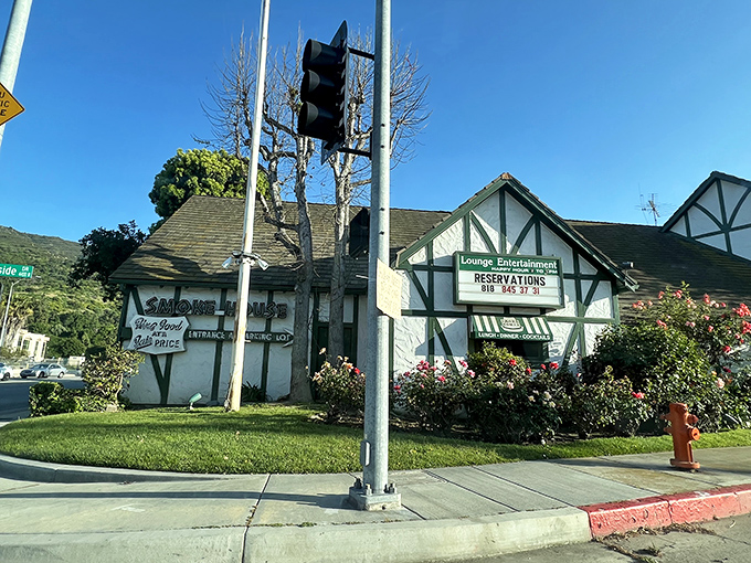 The Tudor-style exterior of The Smoke House stands like a time capsule from Hollywood's golden age, welcoming diners with nostalgic charm.