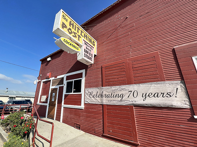 The iconic red exterior of the Hitching Post stands like a time capsule in Casmalia, celebrating over 70 years of carnivorous excellence.