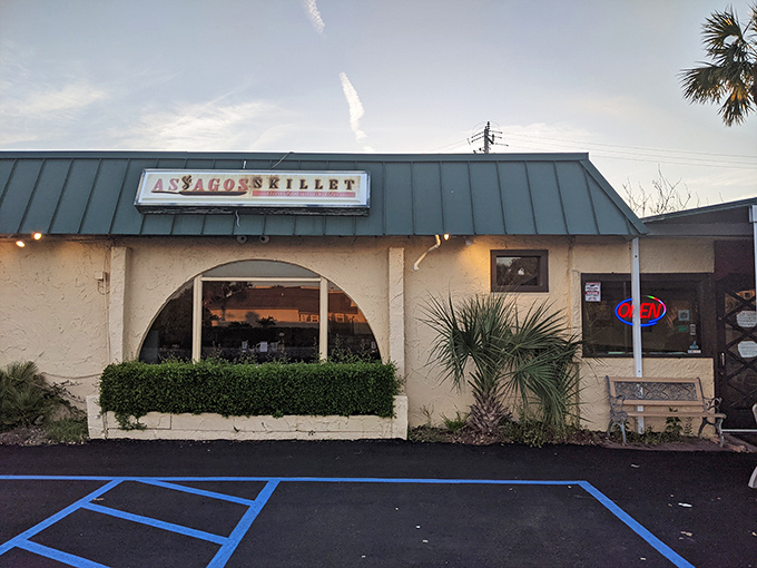 The unassuming exterior of Asiago's Skillet, where breakfast dreams come true beneath Fort Walton Beach's iconic water tower. Hidden gems rarely advertise themselves.