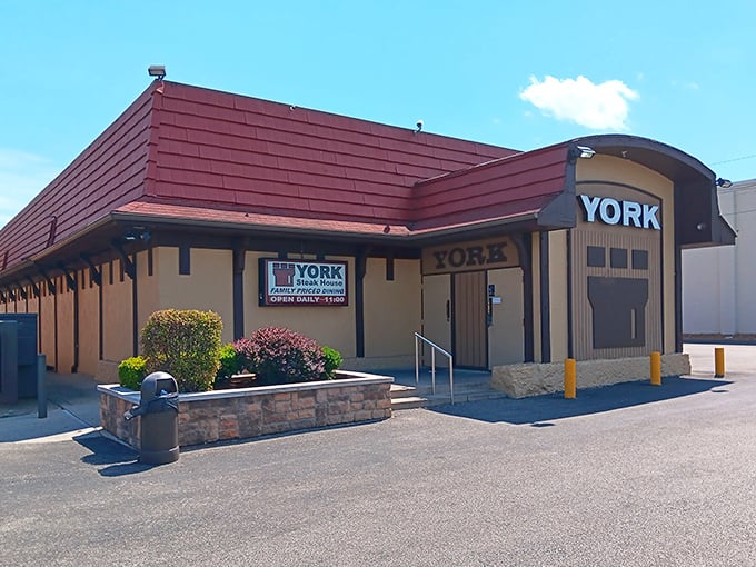 The iconic burgundy roof and beige exterior of York Steak House stands as a time capsule of American dining history, promising "Family Priced Dining" that delivers on both nostalgia and flavor.