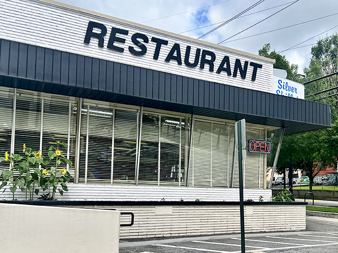 The unmistakable mid-century charm of Silver Skillet's exterior stands as a time capsule in Atlanta's ever-changing landscape. That neon "OPEN" sign has been beckoning hungry patrons for generations.
