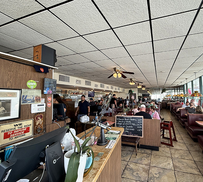The iconic red-trimmed exterior of Jimmy's Eastside Diner stands like a time capsule of American dining culture, palm trees swaying as if to welcome hungry patrons.