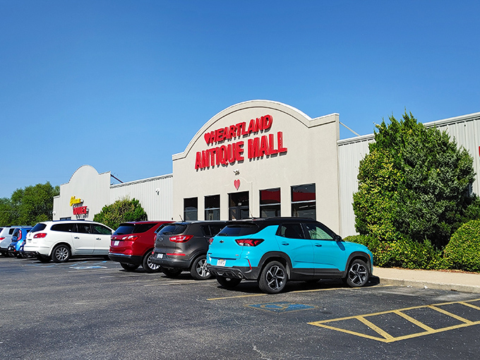 The iconic red lettering of Heartland Antique Mall beckons treasure hunters from miles around, promising adventures that can't be contained by its unassuming exterior.