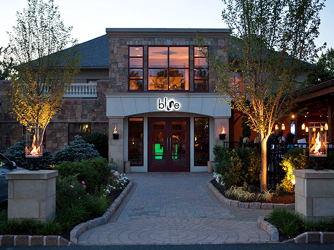 Stone meets sophistication at Blue Grillhouse's exterior, where Pennsylvania charm gets dressed up for a night on the town. Evergreen sentinels stand guard at this culinary fortress.