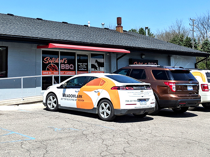 The unassuming exterior of Satchel's BBQ proves once again that the best smoke joints often hide in plain sight. Barbecue paradise awaits behind that red awning.