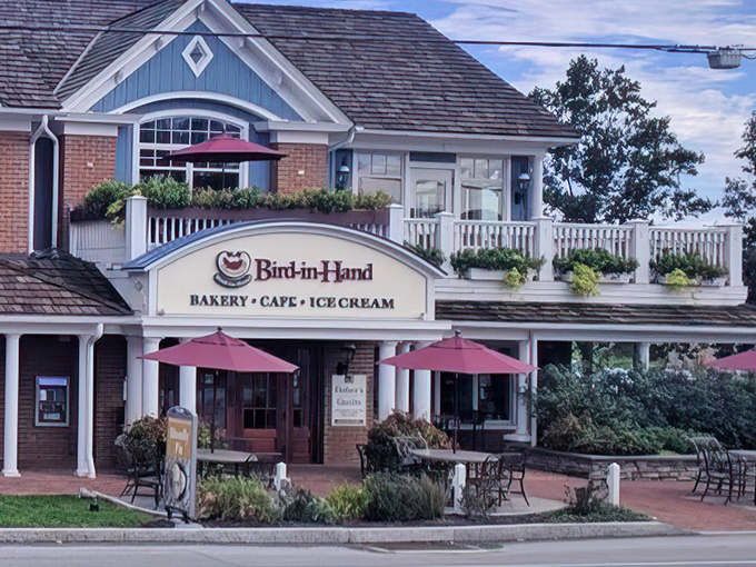 The charming blue and brick exterior of Bird-in-Hand Bakery & Cafe stands like a delicious mirage in Amish Country, complete with inviting porch seating.