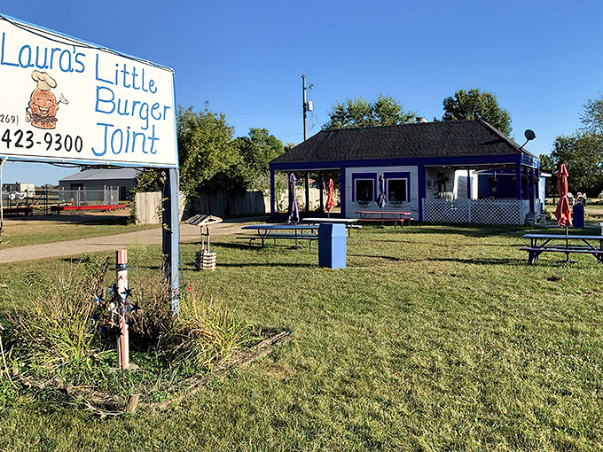 The blue-roofed burger sanctuary beckons from the roadside, promising simple pleasures that no fancy restaurant could ever replicate.