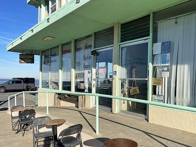 The mint-green facade of Chit Chat Cafe stands like a humble sentinel at the edge of the Pacific, promising simple pleasures and million-dollar views.