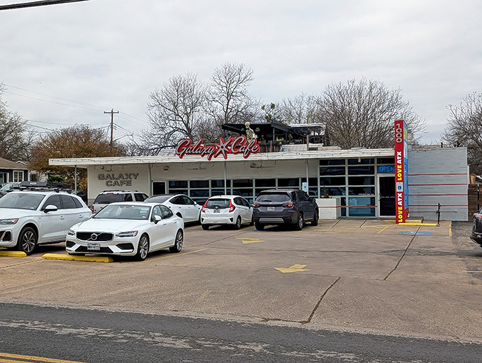 The iconic red Galaxy Cafe sign welcomes hungry Austinites like a beacon of breakfast hope. Simple exterior, extraordinary flavors await inside.