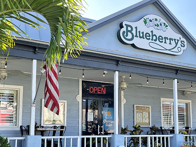 Blueberry's charming cottage exterior says "slow down and eat something wonderful" with its welcoming porch and tropical landscaping.