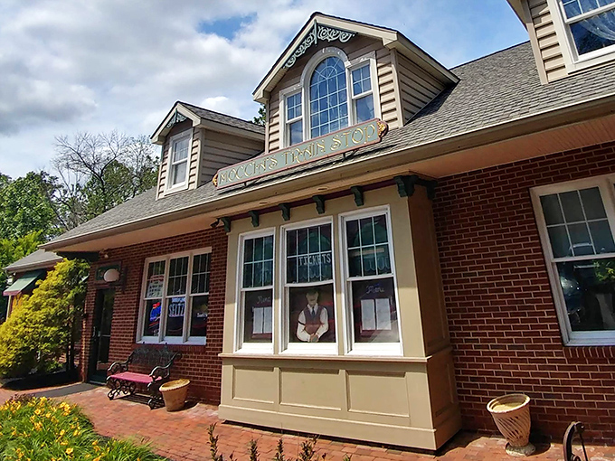 The charming brick exterior of Moccia's Train Stop welcomes hungry travelers with its cozy dormers and warm glow at dusk.