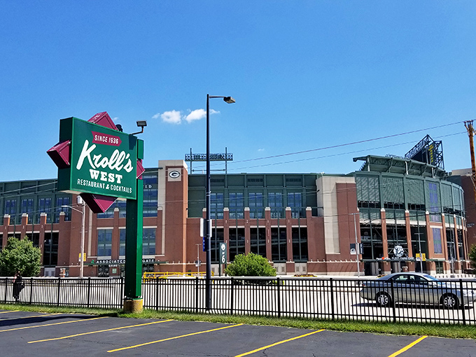 The ultimate Wisconsin power couple: Kroll's West's iconic sign standing proudly across from the cathedral of cheese and football, Lambeau Field.