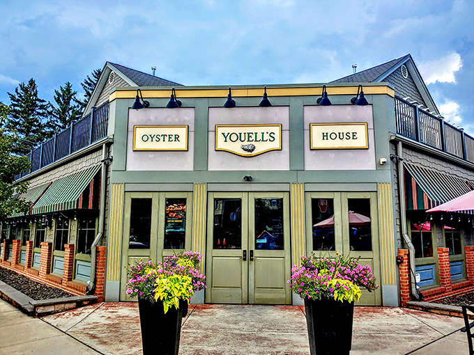 That charming green facade with cheerful awnings practically whispers "fresh seafood awaits inside these welcoming doors."