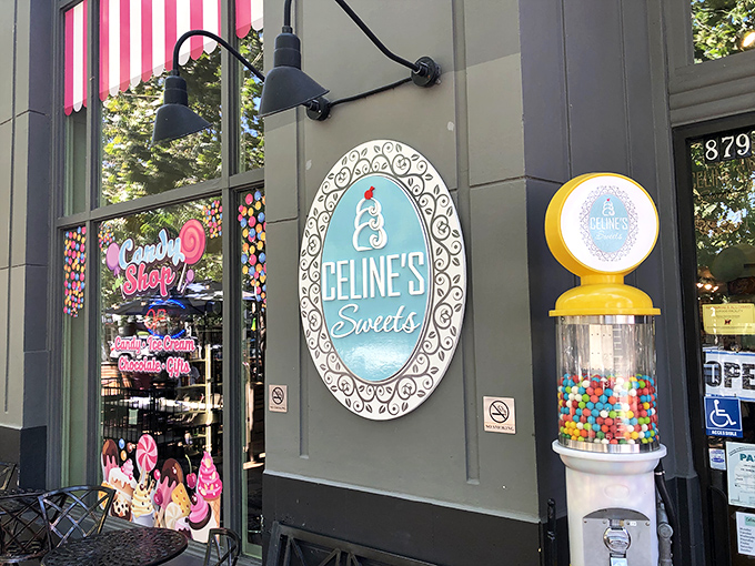 The pink-and-white striped awning and cheerful yellow gumball machine stand like sentinels of sweetness, beckoning sugar-seekers into this candy wonderland.