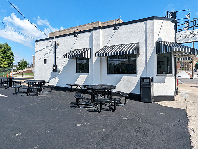 The unassuming white building with its jaunty black-and-white striped awnings stands like a time capsule of American burger history in downtown Fort Wayne.