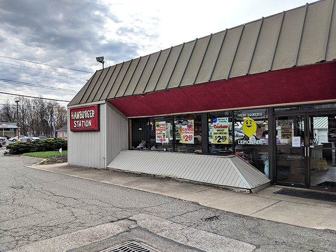 The iconic red sign beckons like a lighthouse for hungry travelers. Simplicity in architecture that promises complexity in flavor.