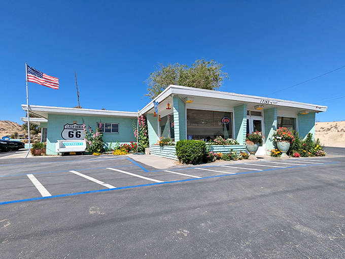 A slice of Route 66 heaven painted turquoise, where the American flag waves as proudly as the diner's reputation for comfort food excellence.