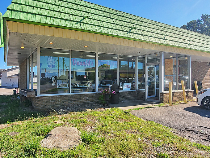 The iconic lime-green roof of Donald's Donuts stands as a beacon of hope for the sugar-deprived masses of Zanesville. Sweet salvation awaits within.