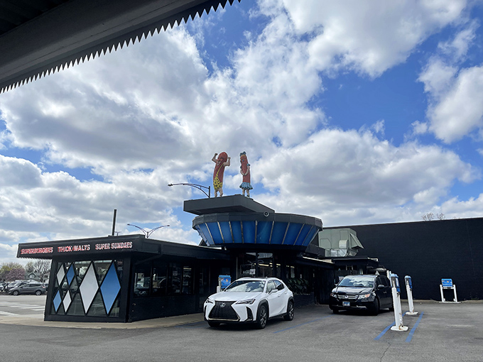 Those iconic hot dog mascots on the roof aren't just waving – they're beckoning you into a time capsule of Chicago culinary history.