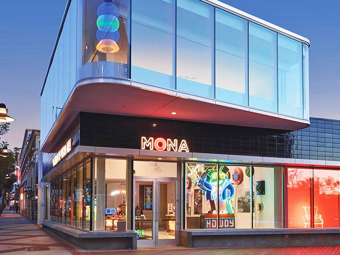 MONA's striking glass fa&ccedil;ade transforms from museum by day to glowing art installation by night, beckoning curious passersby into its luminous world.