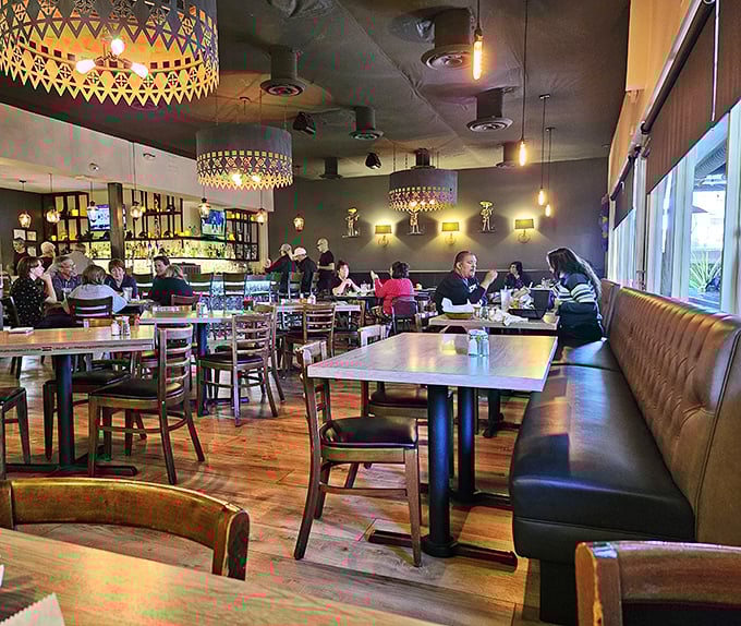 Step inside where geometric pendant lights and warm leather banquettes create the perfect backdrop for serious chimichanga business.