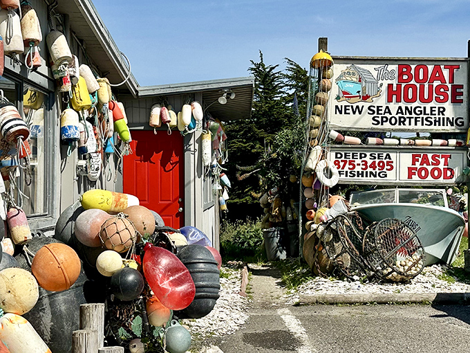 The unassuming exterior of The Boat House, where colorful buoys hang like Christmas ornaments, promising seafood treasures within rather than holiday cheer.