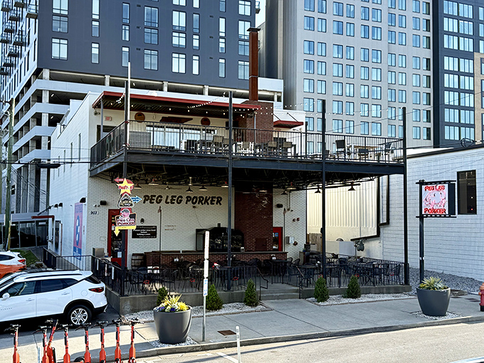 The neon pig sign glows like a barbecue beacon against Nashville's skyline, promising smoky salvation to hungry souls wandering The Gulch.