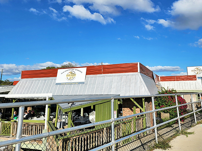 Old Florida charm meets lakeside dining at its finest. The metal roof and green accents of Fish Camp Lake Eustis promise authentic flavors without pretension.