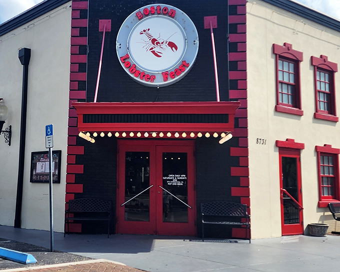 The unmistakable red and white fa&ccedil;ade of Boston Lobster Feast stands like a lighthouse for seafood lovers, beckoning with its giant lobster sign.