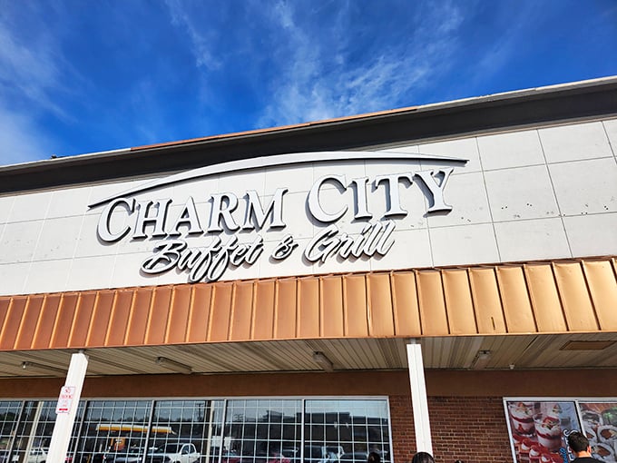The gleaming sign against a blue Maryland sky promises what every hungry traveler seeks: unlimited culinary possibilities with a side of Old Bay seasoning.