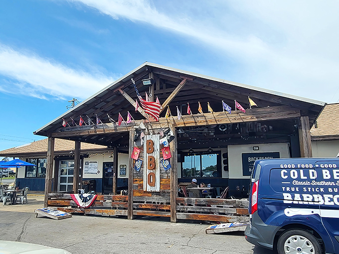 The rustic wooden porch says "serious barbecue joint" before you even smell the smoke. Like finding a treasure map where X marks the brisket.