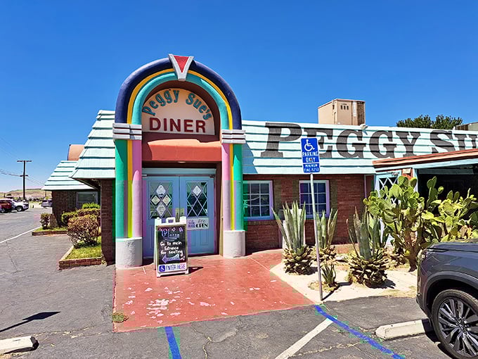 The rainbow-arched entrance to Peggy Sue's stands like a Technicolor beacon in the desert, promising a time-traveling culinary adventure just off I-15.