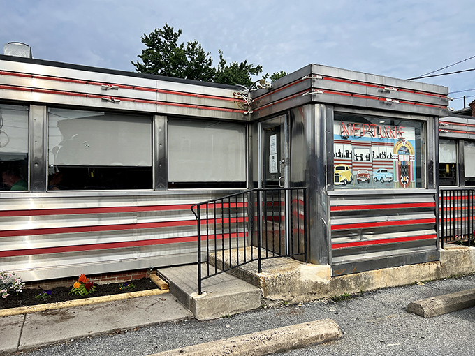 The classic red-striped exterior of Neptune Diner gleams like a time machine parked conveniently in Lancaster, promising nostalgic comfort with every meal.