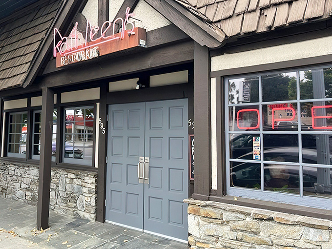 The charming cottage-like exterior of Kathleen's Restaurant beckons with its stone facade and distinctive blue doors—like a storybook breakfast haven come to life.