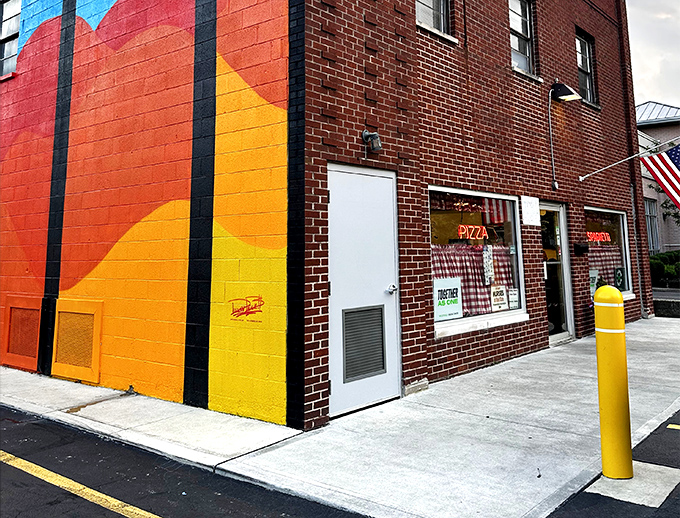 The vibrant mural on this brick building isn't just eye-catching—it's a beacon for pizza pilgrims who've been making the journey to this Bexley landmark for generations.