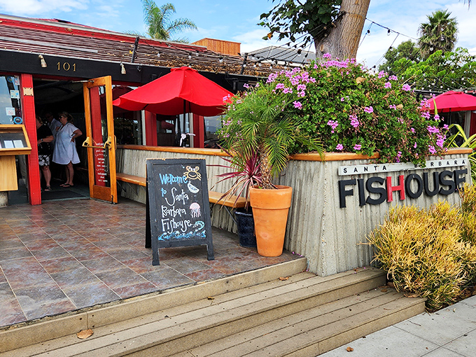 A coastal welcome that feels like a warm hug – vibrant bougainvillea frames the entrance to Santa Barbara FisHouse, where seafood dreams come true.