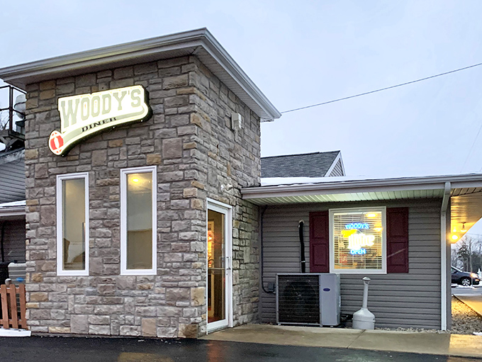 The stone facade of Woody's Diner stands like a culinary fortress in Russells Point, promising comfort food treasures within its unassuming walls.