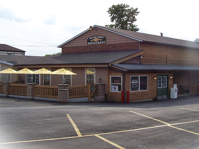 The wooden exterior of Village Family Restaurant beckons like an old friend, complete with sunny yellow umbrellas promising outdoor dining when Ohio weather cooperates.