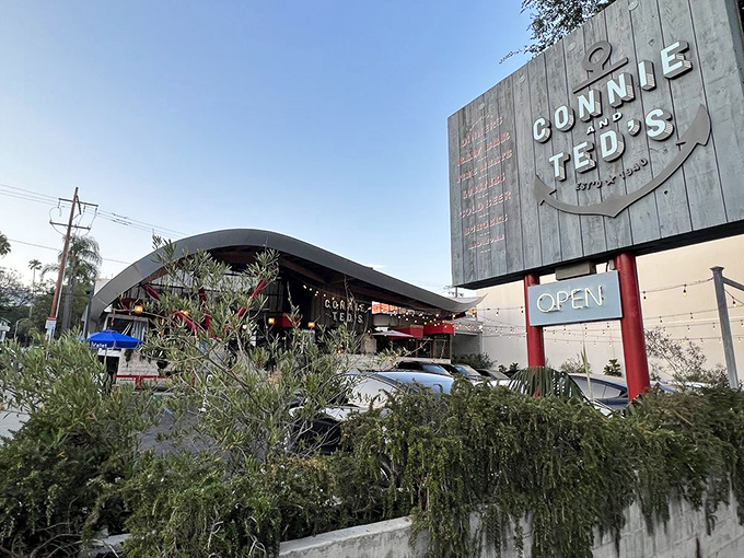 The architectural marvel that is Connie and Ted's stands proudly against the California blue sky, its wave-like roof a nod to the oceanic treasures within.
