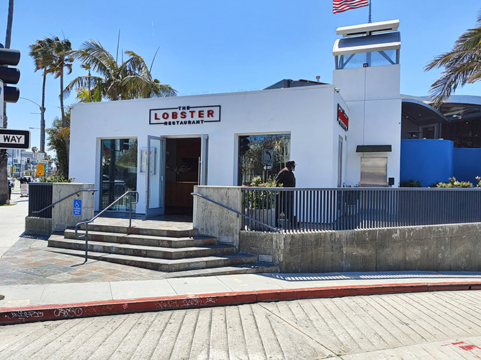 The iconic white exterior of The Lobster stands sentinel at the entrance to Santa Monica Pier, promising seafood treasures with ocean views that'll make your Instagram followers weep.