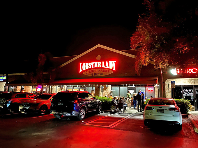 The glowing red sign of Lobster Lady beckons seafood lovers like a lighthouse guiding hungry sailors to shore.