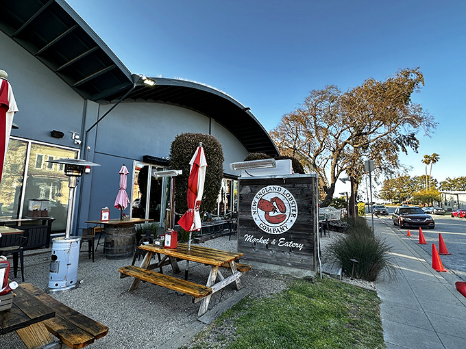 The blue facade with its classic signage promises East Coast authenticity in California. Those picnic tables aren't just seating—they're stages for impending seafood euphoria.