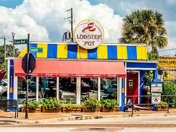 The iconic red awning and circular sign of The Lobster Pot beckon seafood lovers like a lighthouse guiding hungry sailors home.