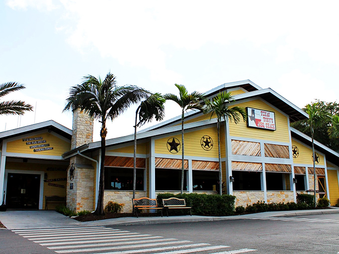 The sunshine-yellow exterior of Texas Tony's stands as a barbecue beacon in Naples, complete with rustic stone chimney and Western star accents.