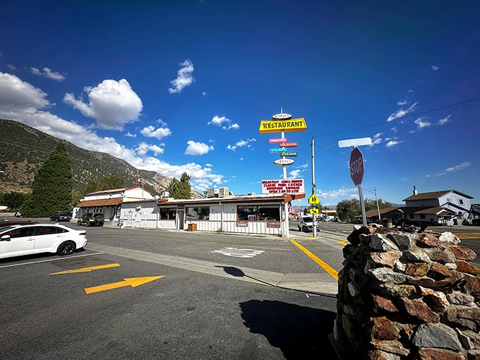 The humble yellow "RESTAURANT" sign against Sierra Nevada's majestic backdrop is California's version of a desert mirage—except this oasis actually delivers.