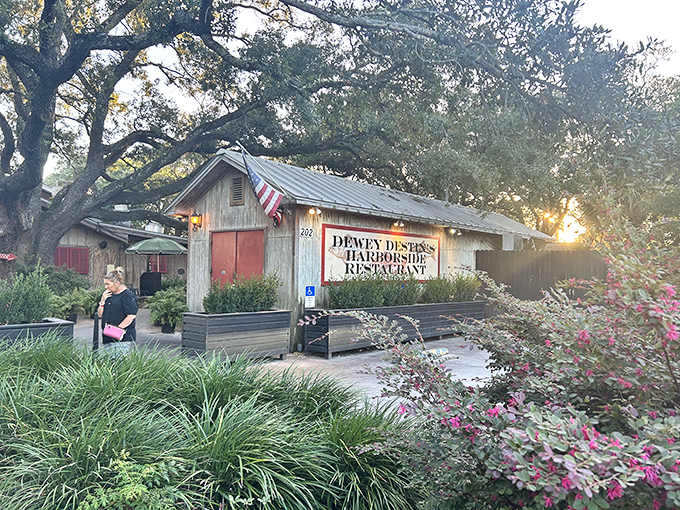 Rustic charm meets coastal magic at Dewey Destin's, where the weathered wood exterior and flowering landscape whisper, "The best seafood doesn't need fancy packaging."