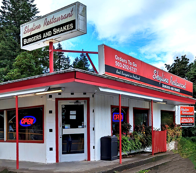 The classic red and white exterior of Skyline Restaurant stands like a time capsule among Portland's evergreens, boldly proclaiming its burger-and-shake mission to the world.