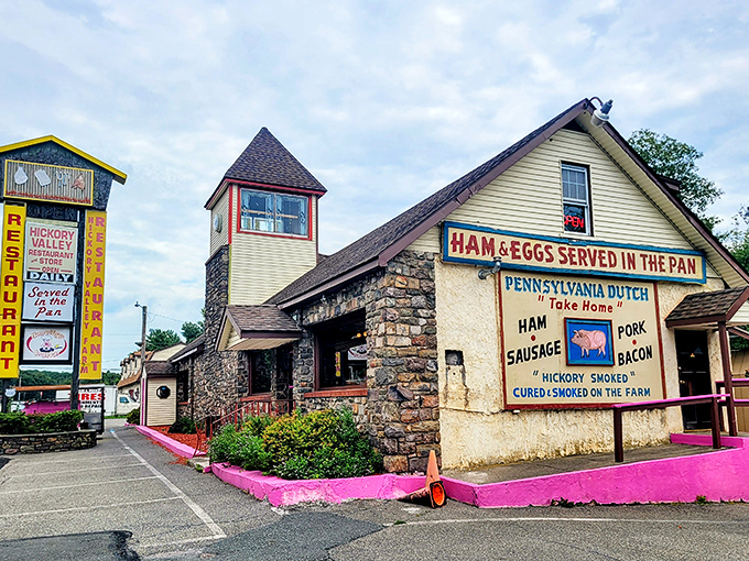 The stone-and-wood exterior of Hickory Valley Farm Restaurant stands as a rustic beacon of comfort food, complete with that unmistakable pink foundation that says, "Yes, we're serious about our brisket."