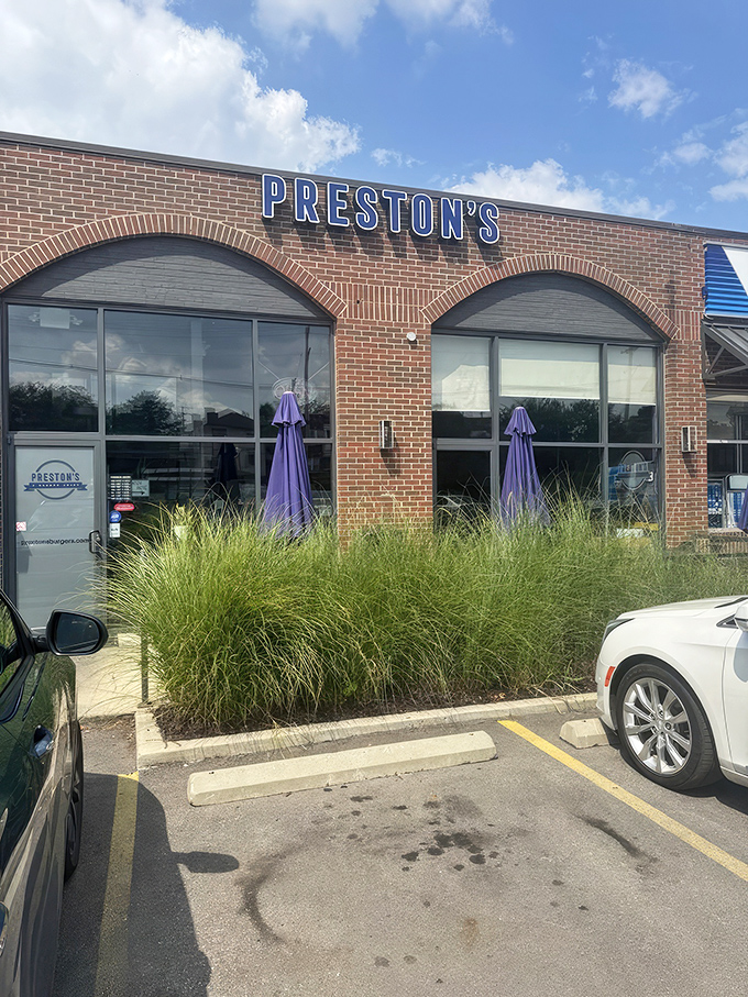 The blue neon "PRESTON'S" sign beckons burger pilgrims like a culinary lighthouse. This unassuming brick storefront houses Columbus's worst-kept delicious secret.